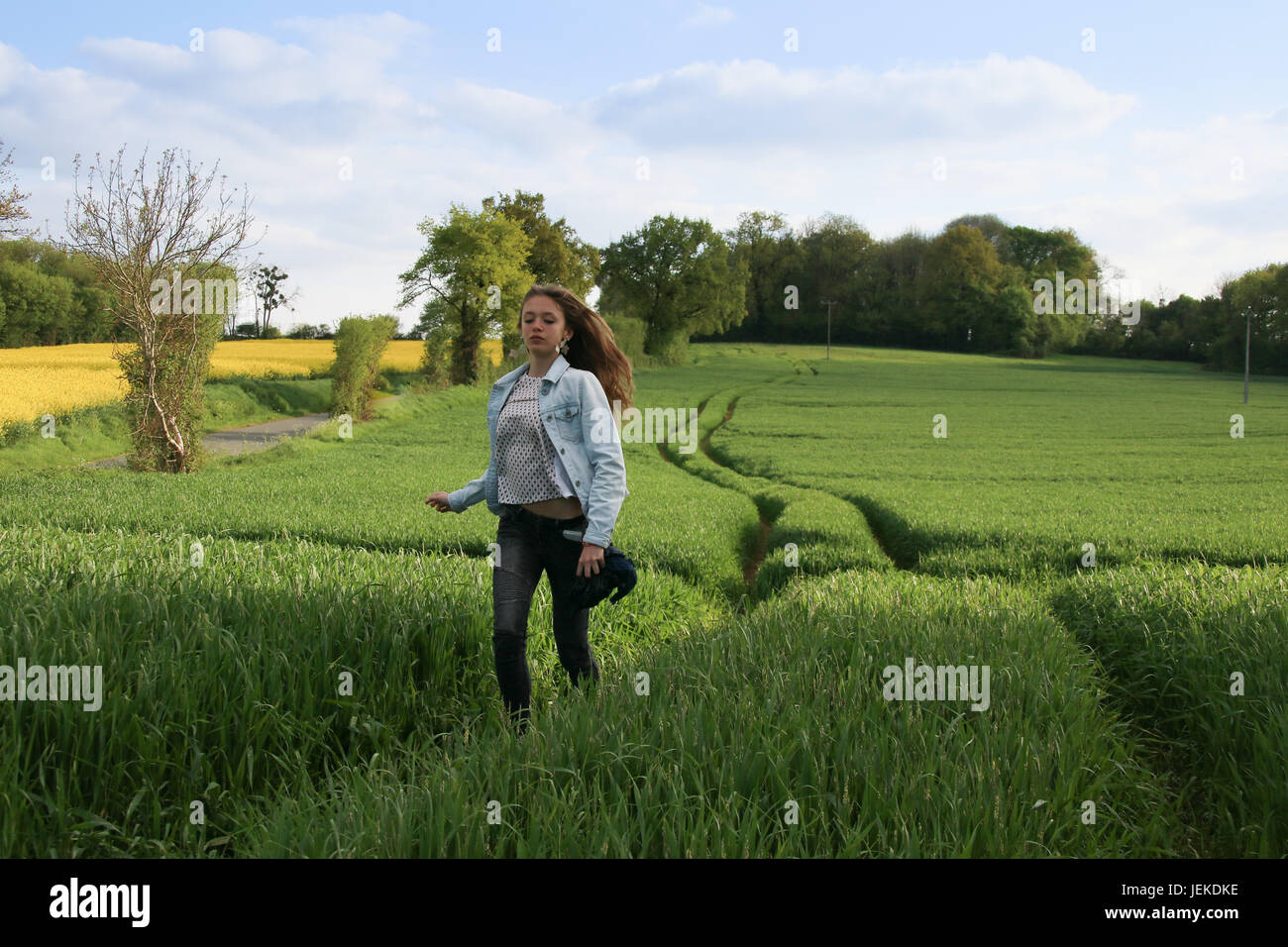 Teenage girl running through a wheat field, Cherveux, France Stock ...