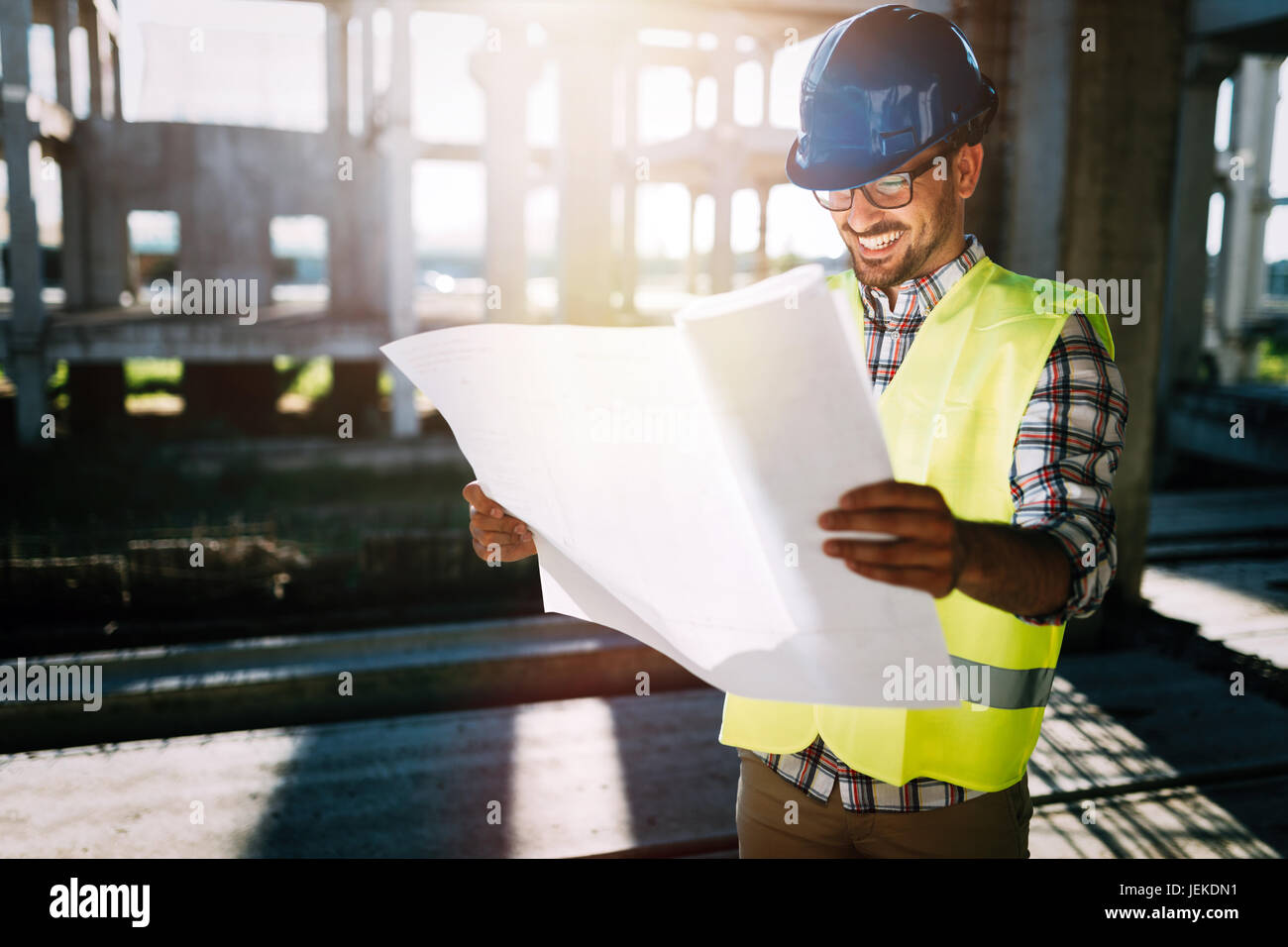 Picture of construction site engineer looking at construction plan ...