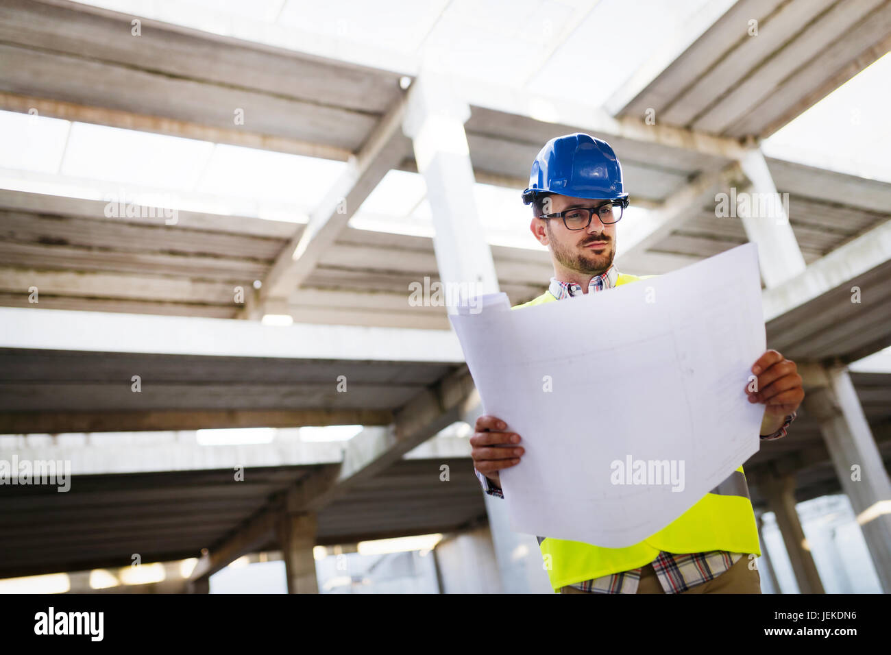 Picture of construction site engineer looking at construction plan ...