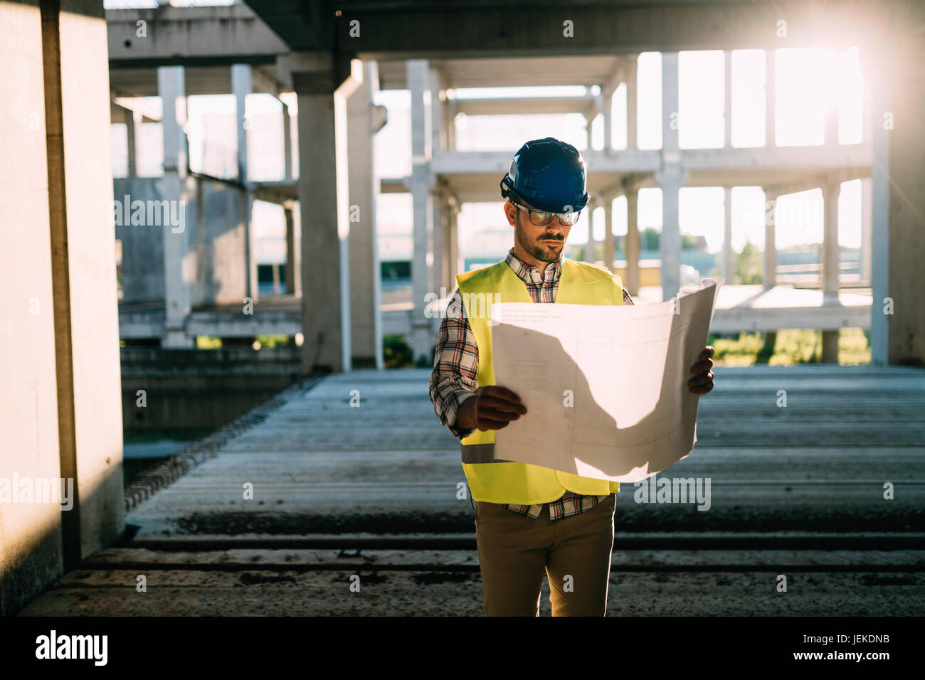 Picture of construction site engineer looking at construction plan ...