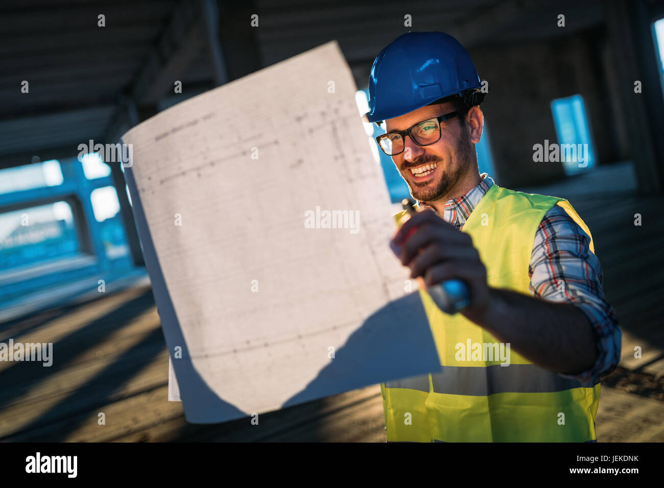 Picture of construction site engineer looking at construction plan ...