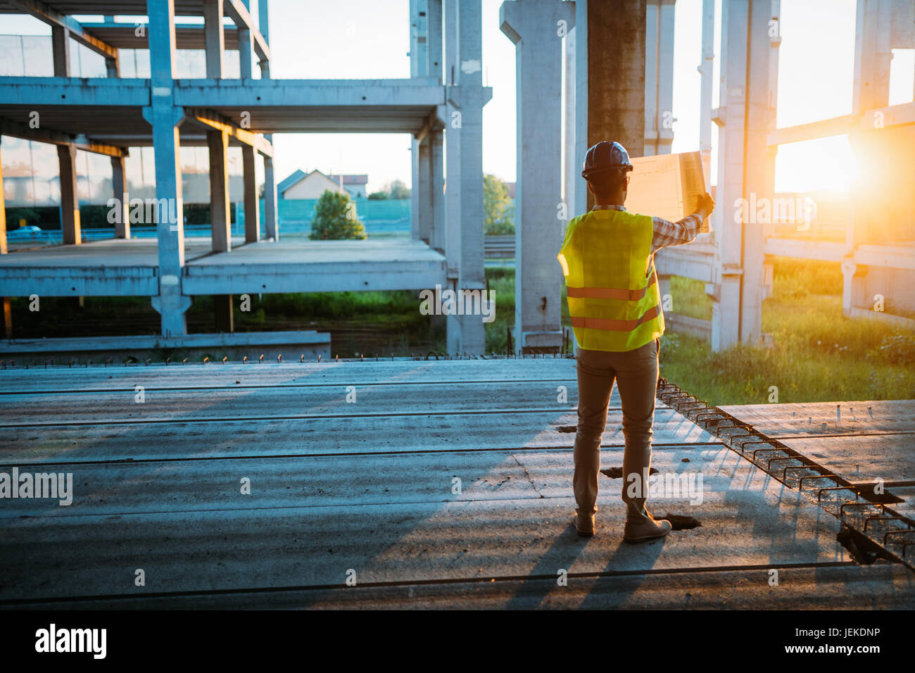 Picture of construction site engineer looking at construction plan ...