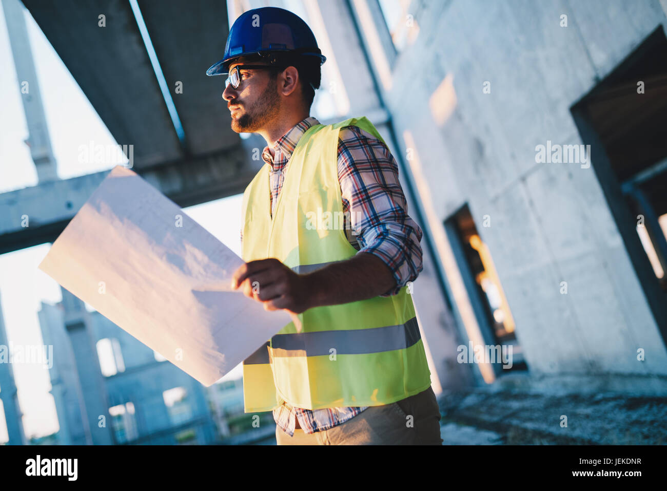 Picture of construction site engineer looking at construction plan ...