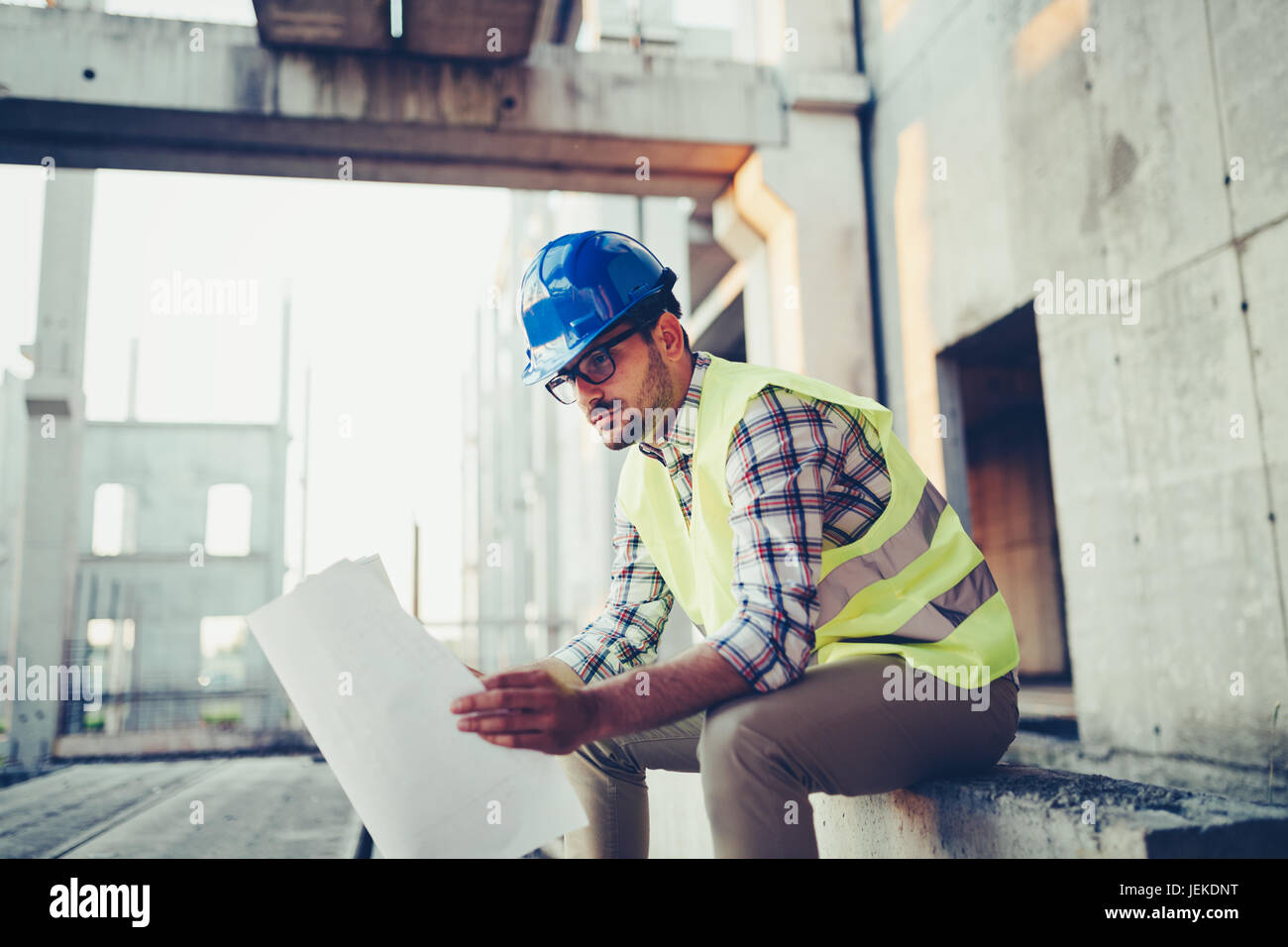 Picture of construction site engineer looking at construction plan ...