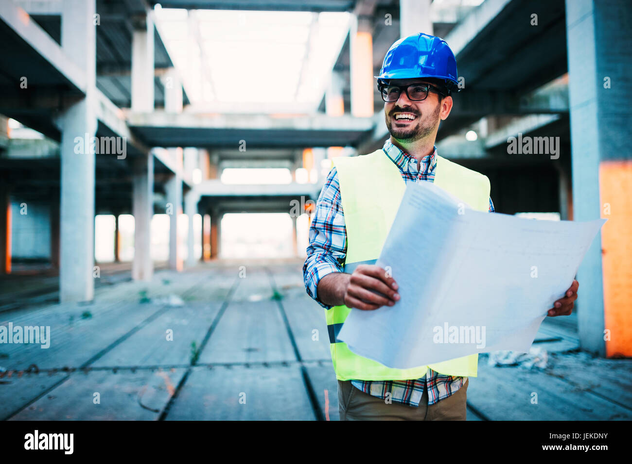 Picture of construction site engineer looking at construction plan ...