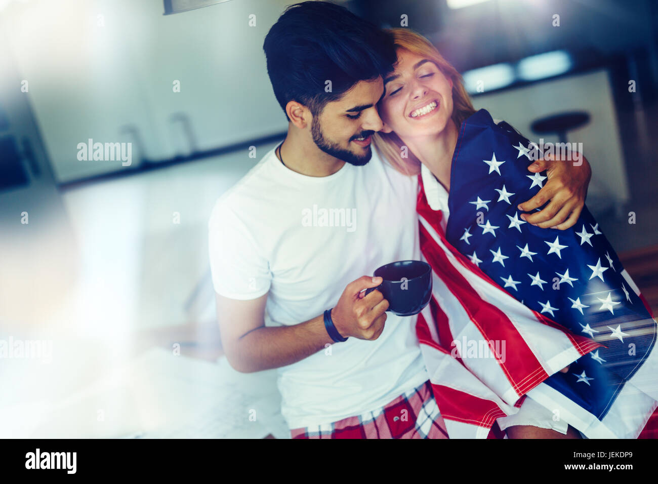 Cute young couple hugging and smiling in their home Stock Photo - Alamy