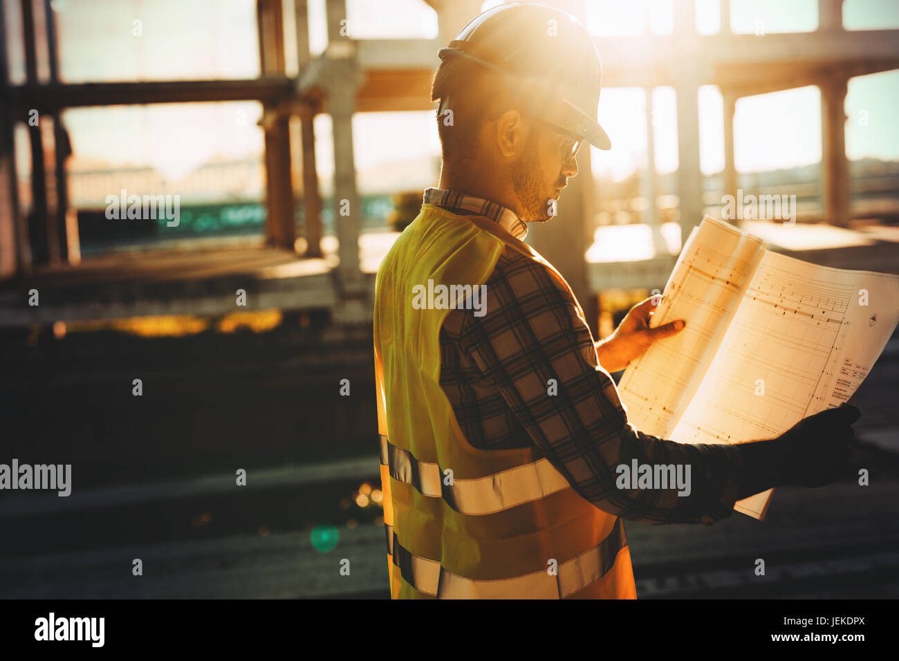 Picture of construction site engineer looking at construction plan ...