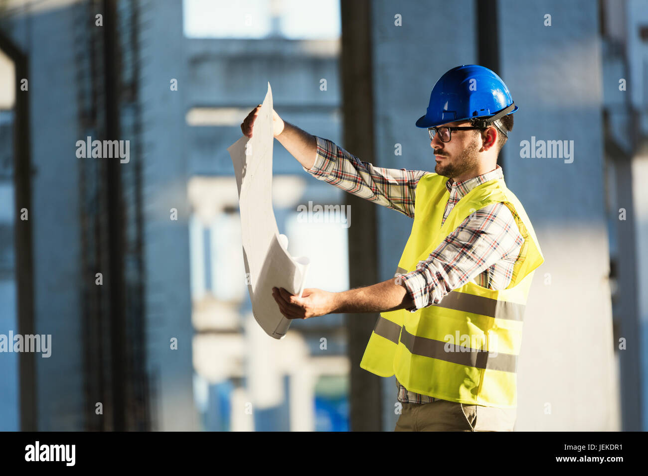 Picture of construction site engineer looking at construction plan ...