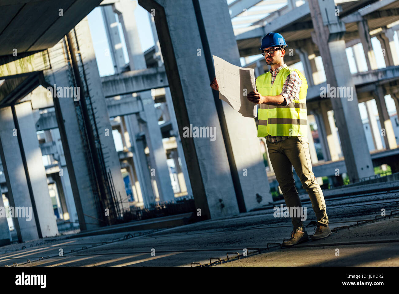 Picture of construction site engineer looking at construction plan ...