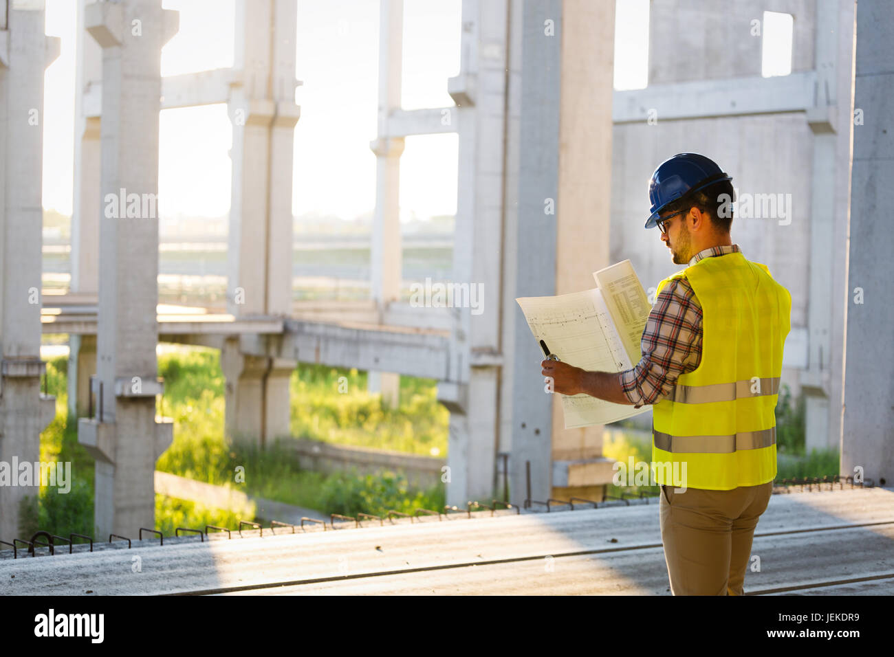 Picture of construction site engineer looking at construction plan ...