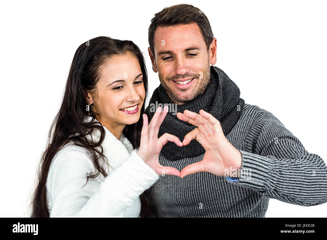 Smiling couple making heart shape with hands Stock Photo - Alamy