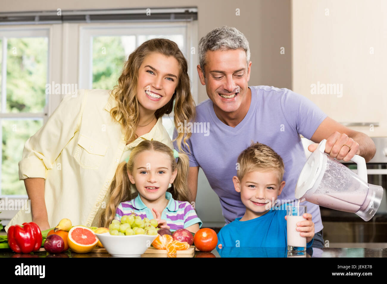 Happy family preparing healthy smoothie Stock Photo - Alamy