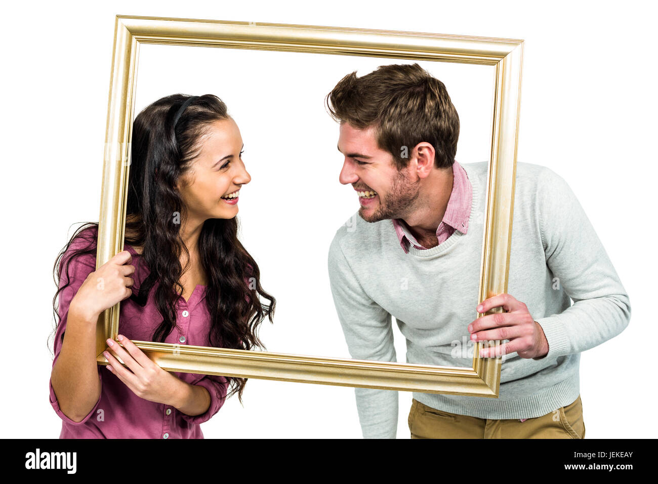 Stylish couple holding picture frame Stock Photo - Alamy