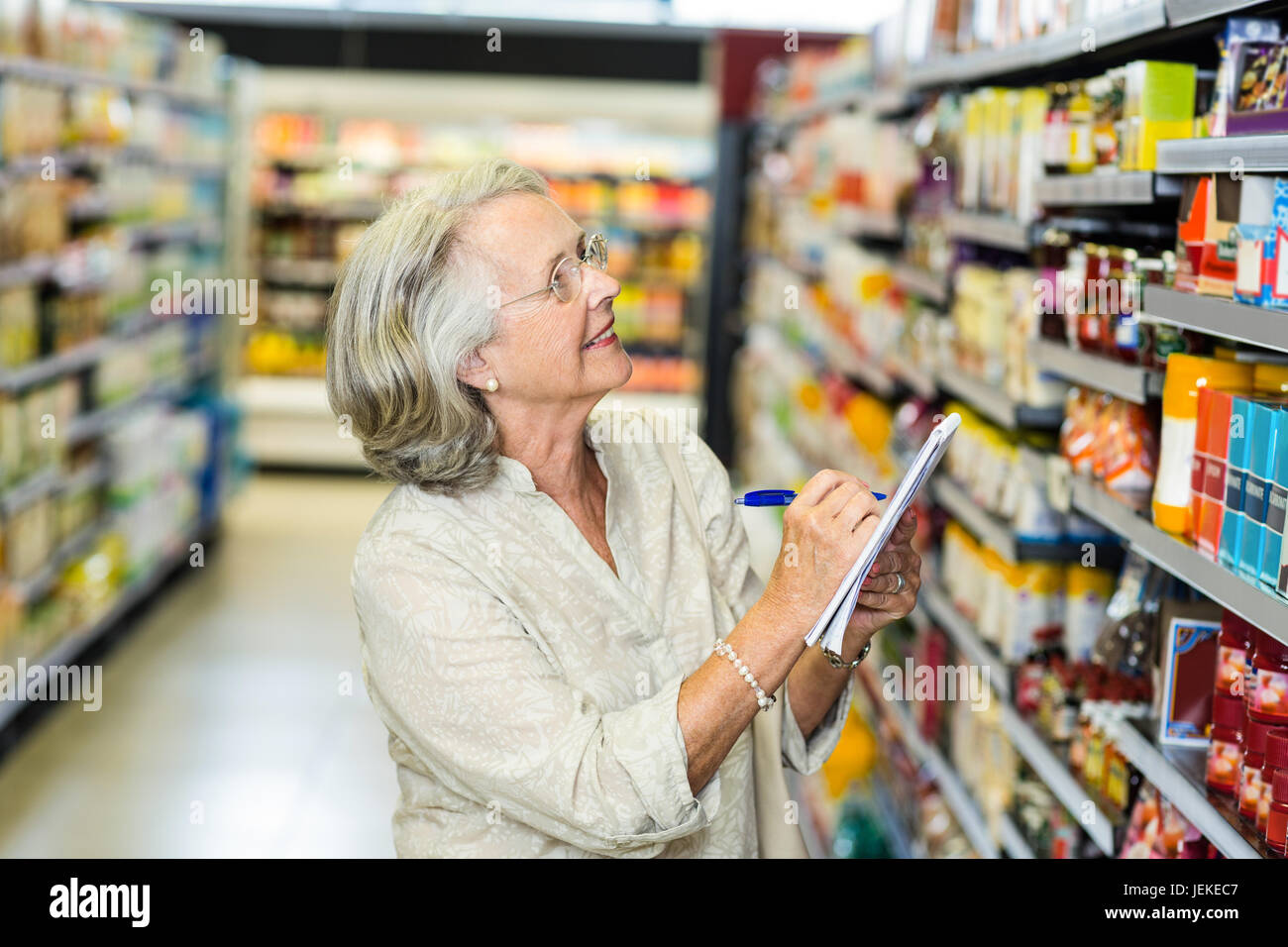 Senior woman checking list Stock Photo - Alamy