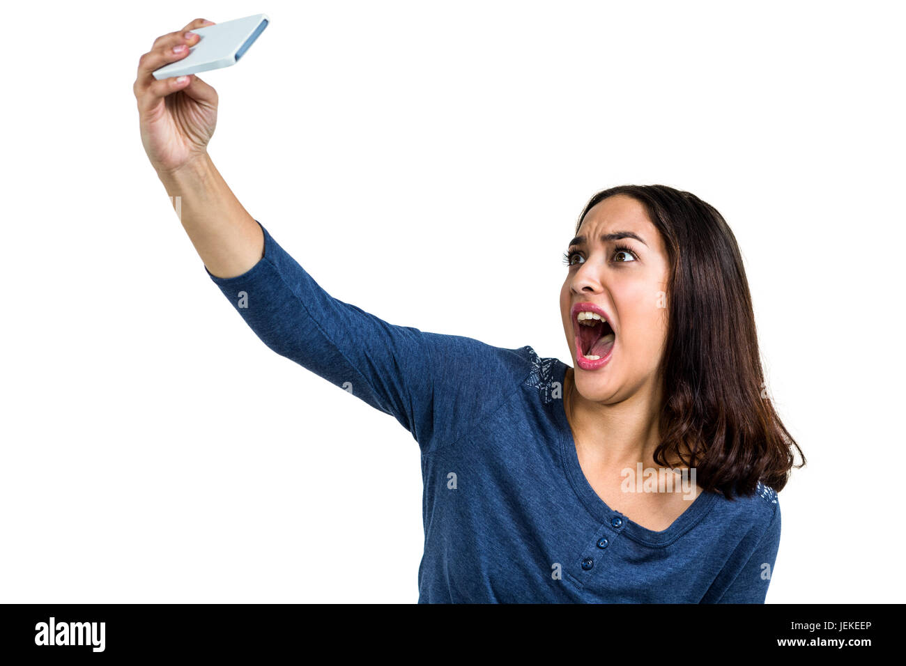 Young woman making face while taking selfie Stock Photo - Alamy