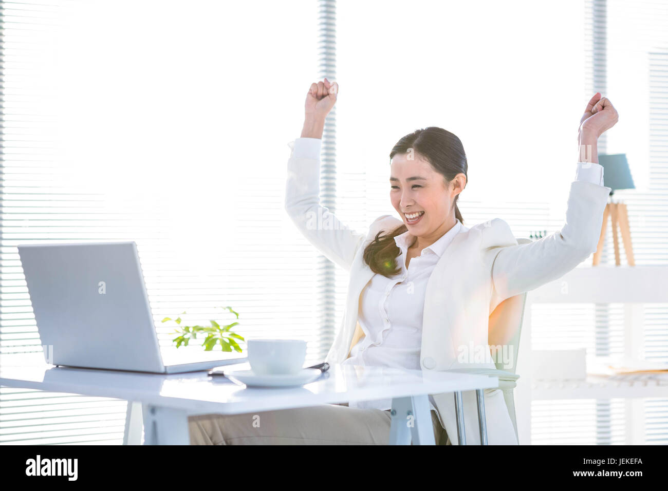 Businesswoman rejoicing with arms outstretched Stock Photo - Alamy