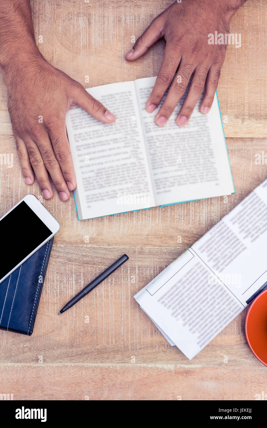 Overhead view of man reading book Stock Photo - Alamy