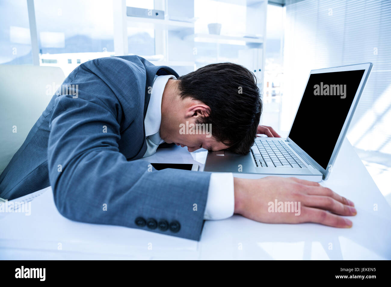 Businessman lying on his desk Stock Photo - Alamy