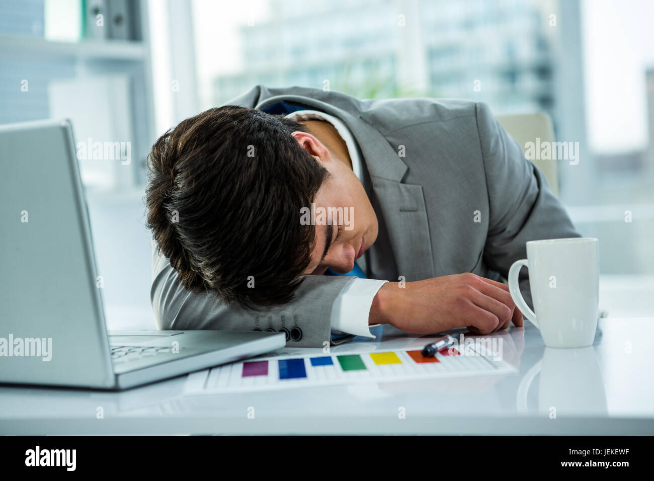 Asian businessman sleeping on his desk Stock Photo - Alamy