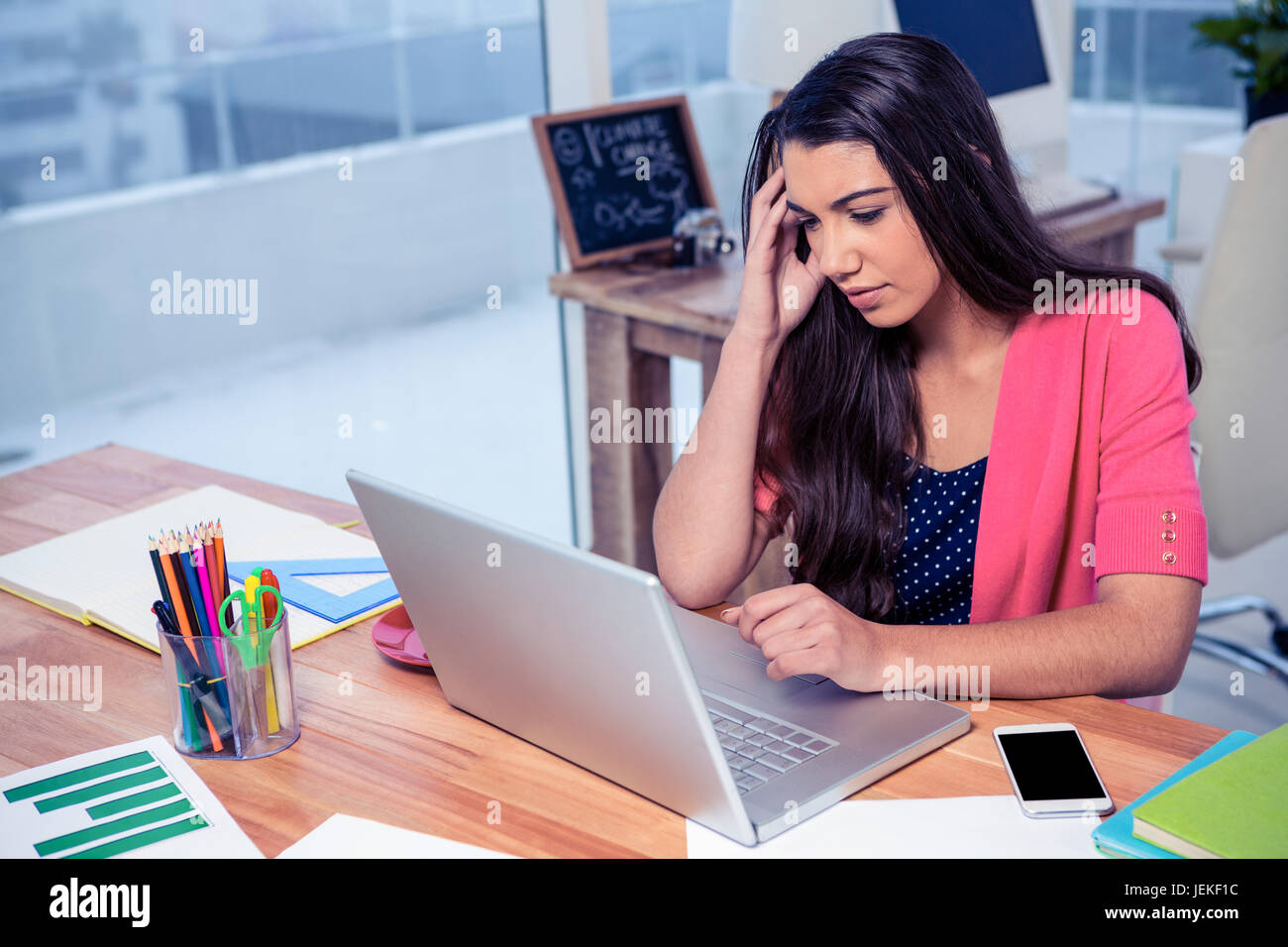 Stressed beautiful businesswoman using laptop Stock Photo - Alamy