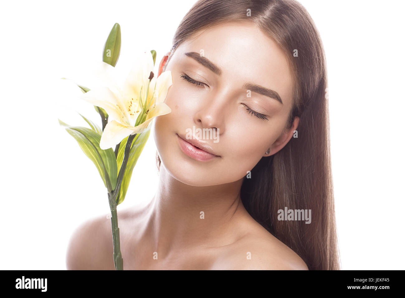 Beautiful young girl with a light natural make-up and perfect skin with ...