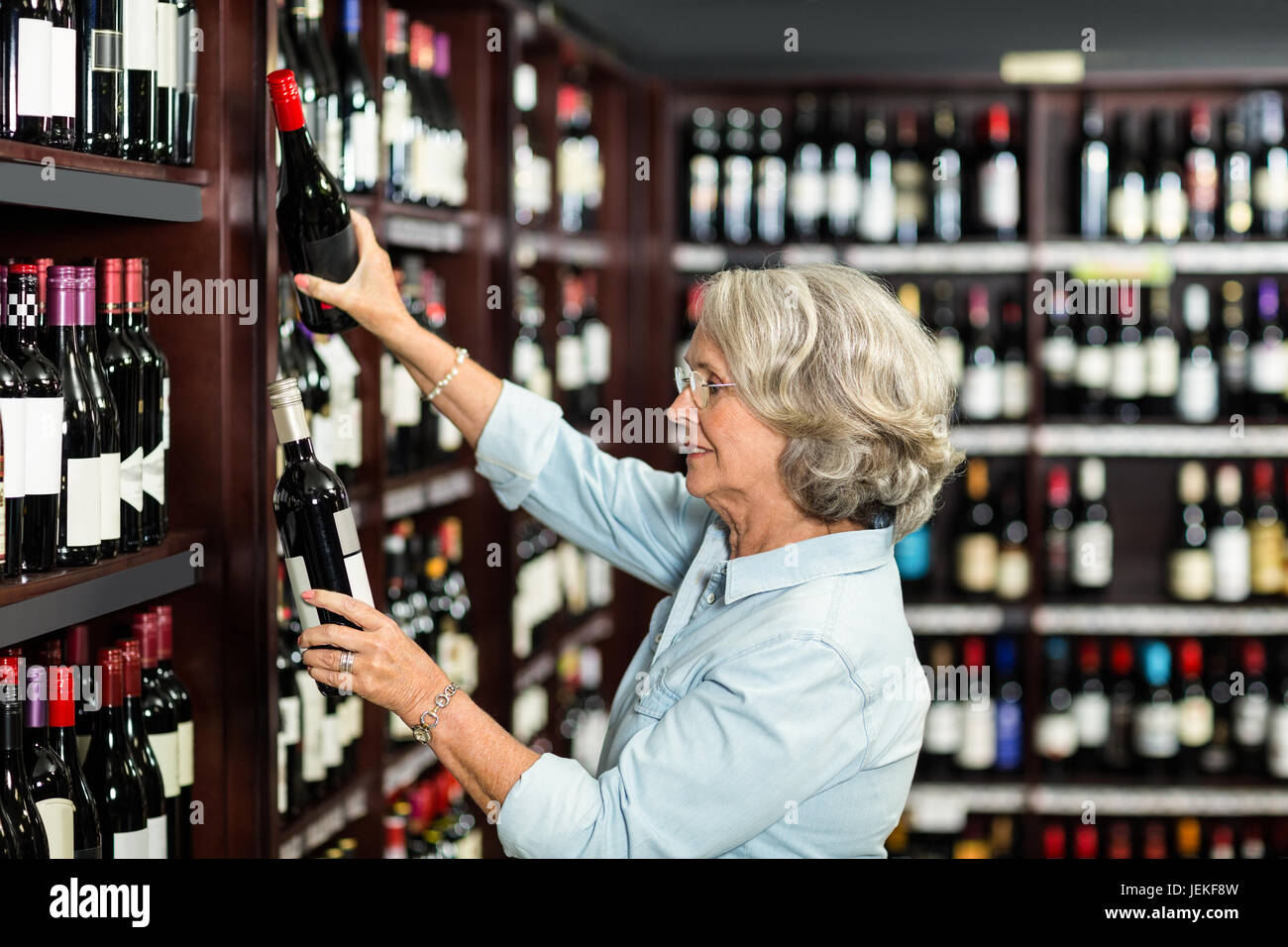 Woman choosing wine liquor store hi-res stock photography and images ...