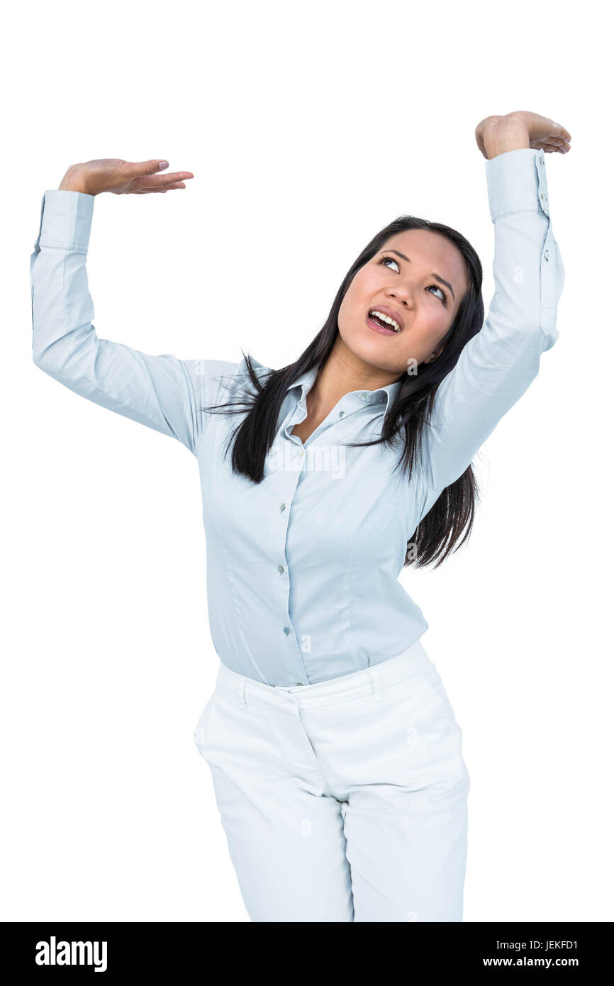 Worried businesswoman pushing something up Stock Photo - Alamy