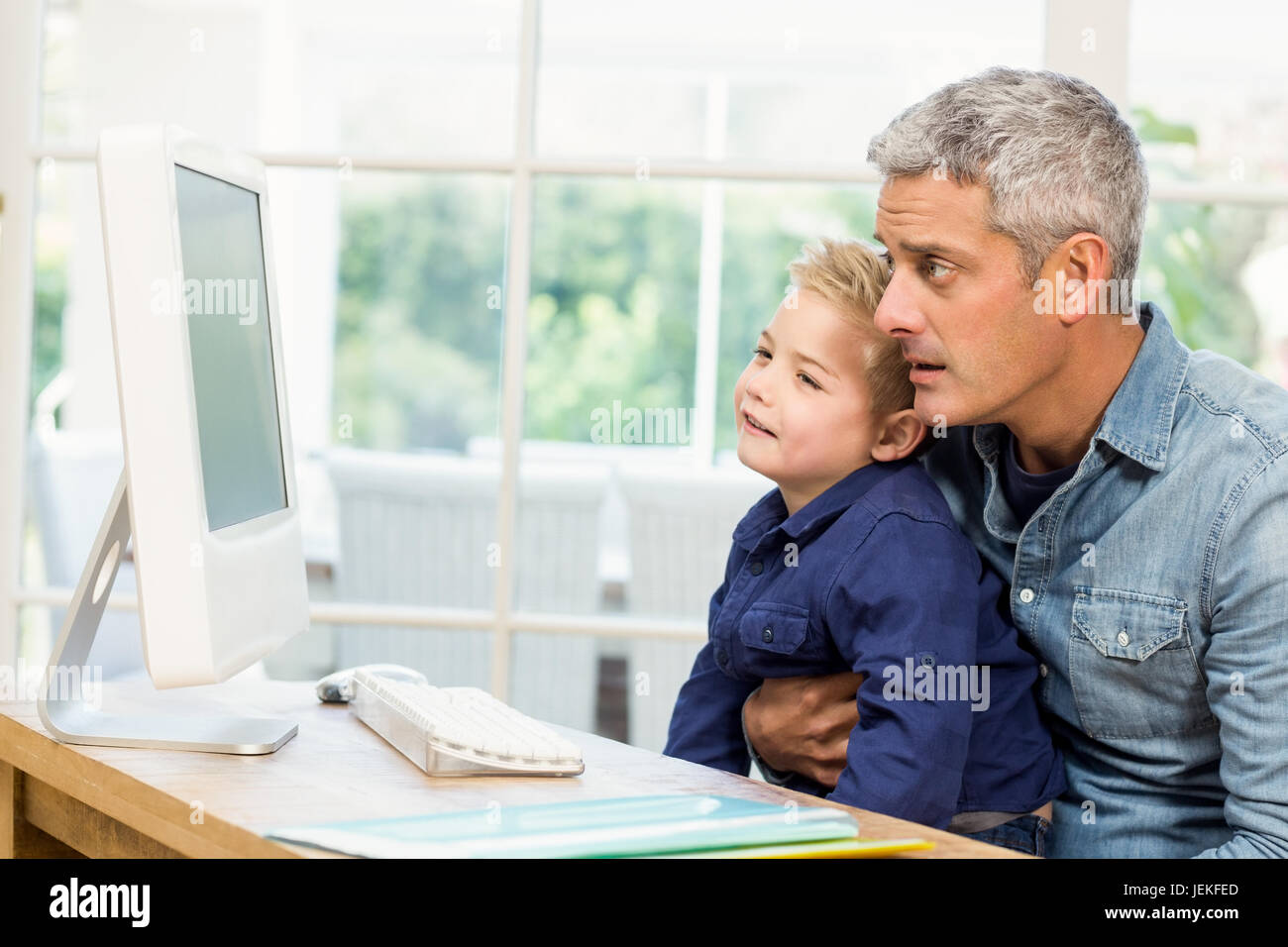 Father and son using the computer Stock Photo - Alamy