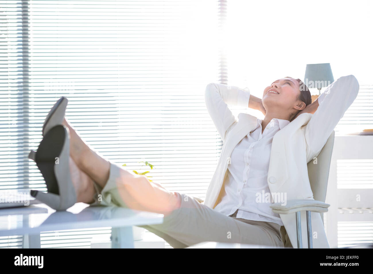Businesswoman relaxing legs on desk hi-res stock photography and images ...