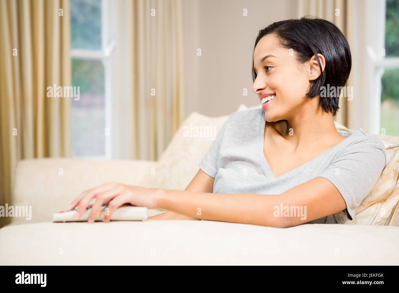 Beautiful woman using tv remote hi-res stock photography and images - Alamy