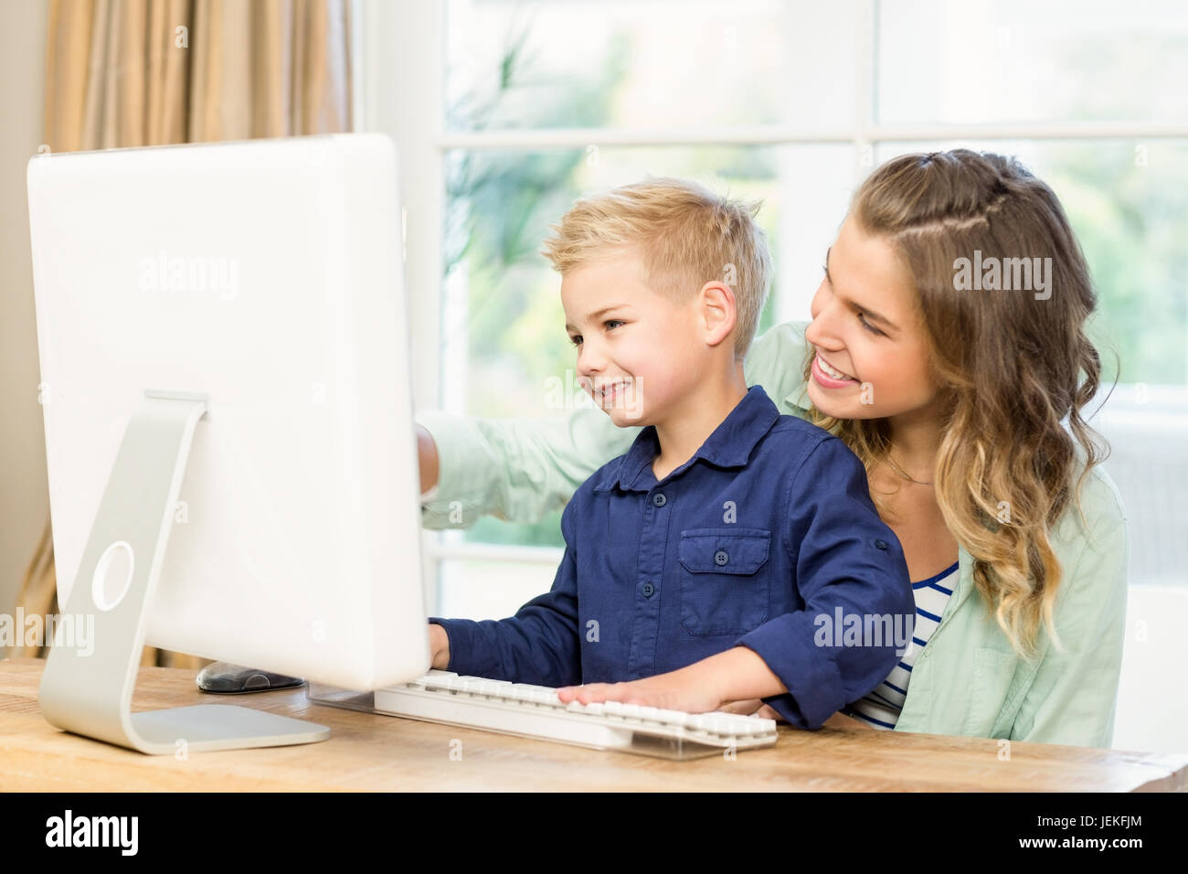 Mother and son using the computer Stock Photo - Alamy