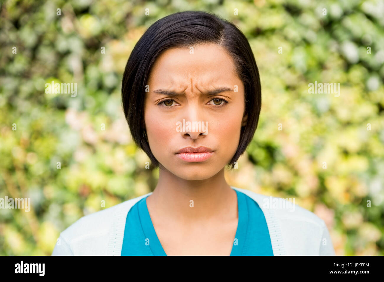 Portrait of frowning brunette Stock Photo - Alamy