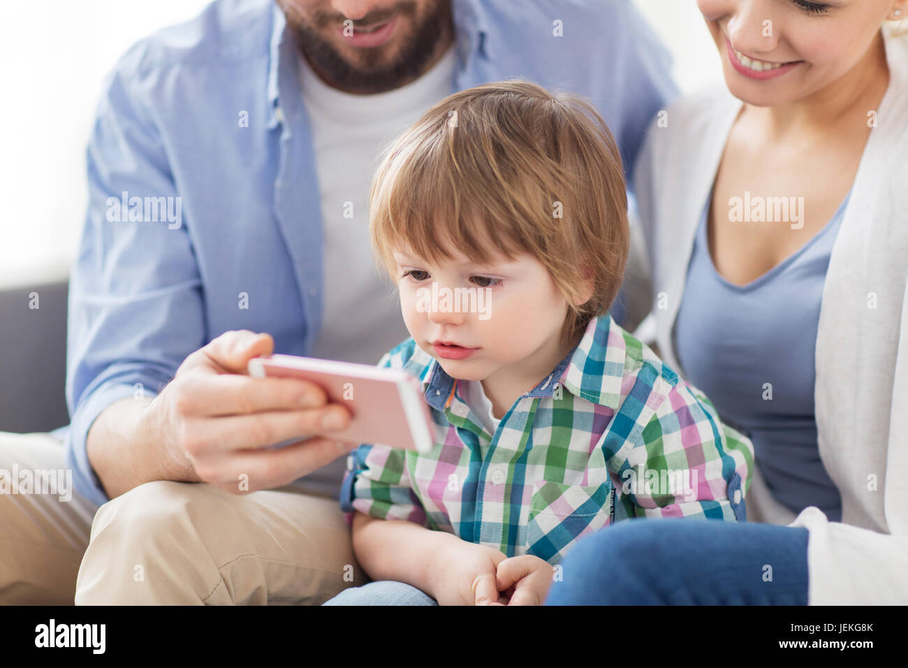happy family with smartphone at home Stock Photo - Alamy