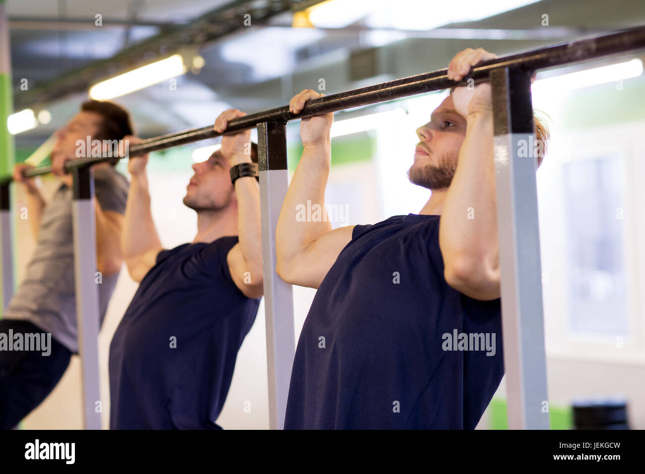 group of young men doing pull-ups in gym Stock Photo - Alamy