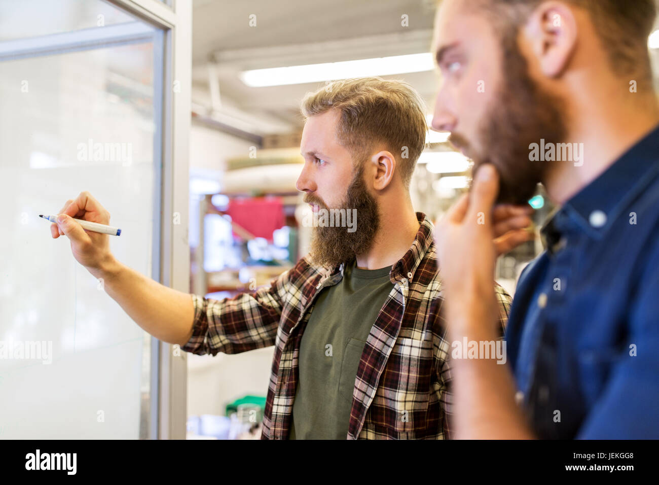 men writing to whiteboard at office Stock Photo - Alamy
