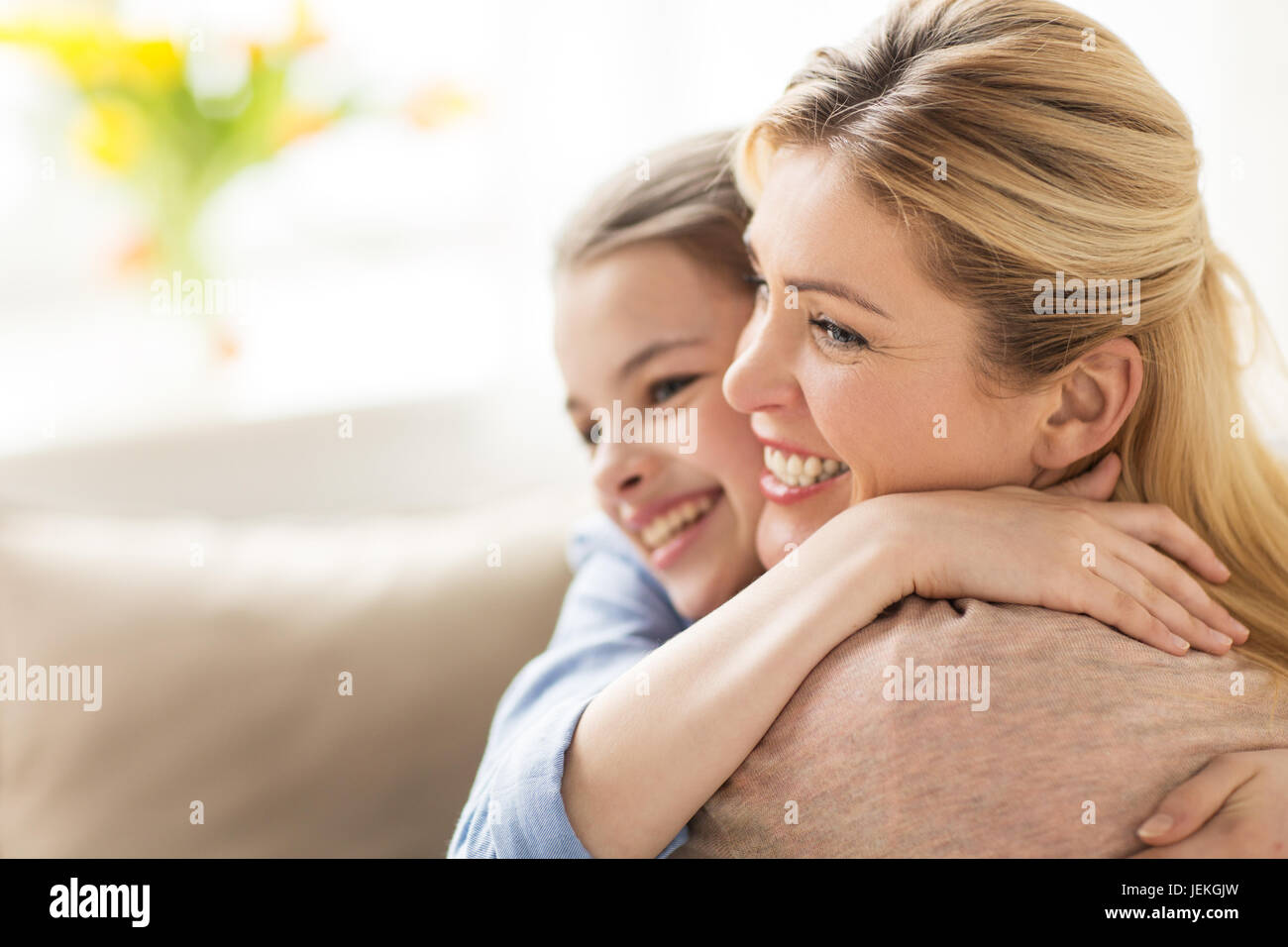 happy smiling family hugging at home Stock Photo - Alamy