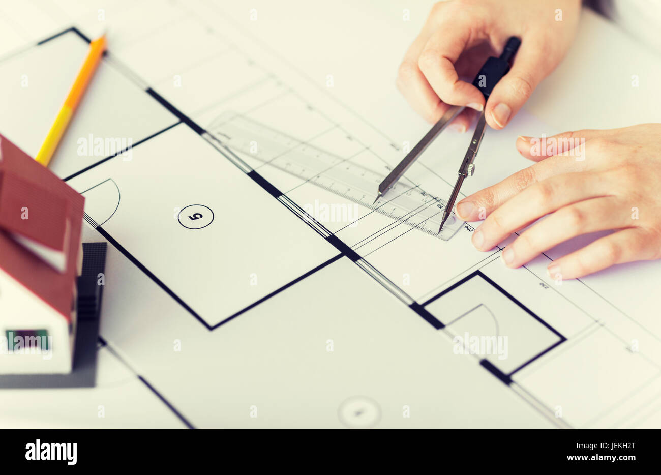 close up of hands with compass measuring blueprint Stock Photo - Alamy