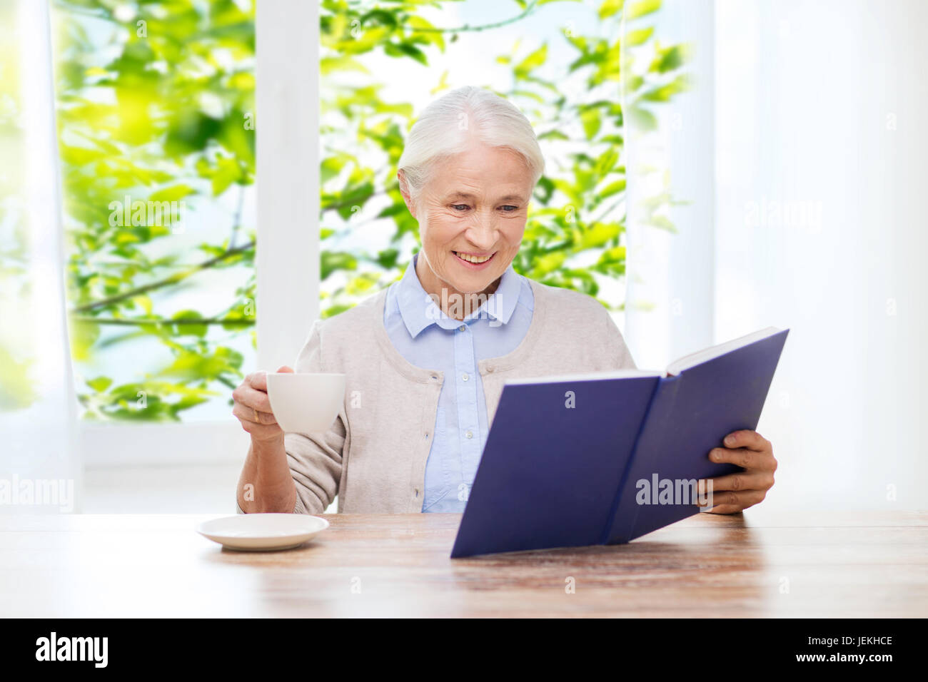happy smiling senior woman reading book at home Stock Photo - Alamy