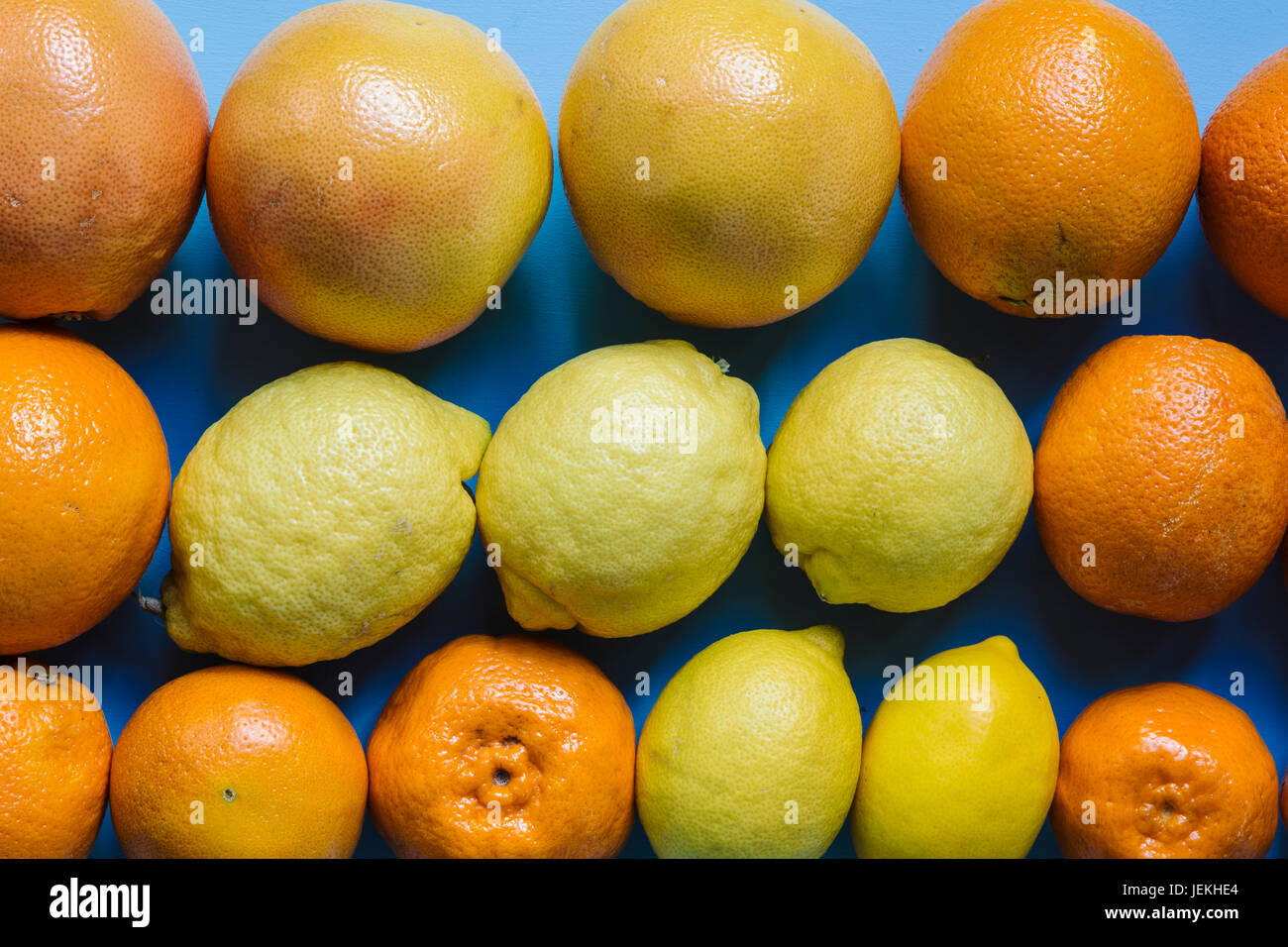 Citrus fruits on blue background Stock Photo - Alamy