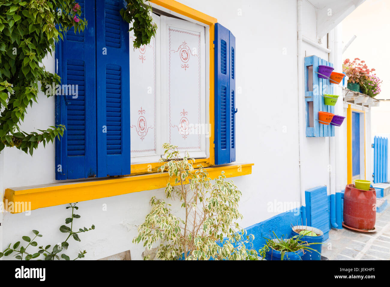 Traditional Greek facade of house with blue colours accents of window ...
