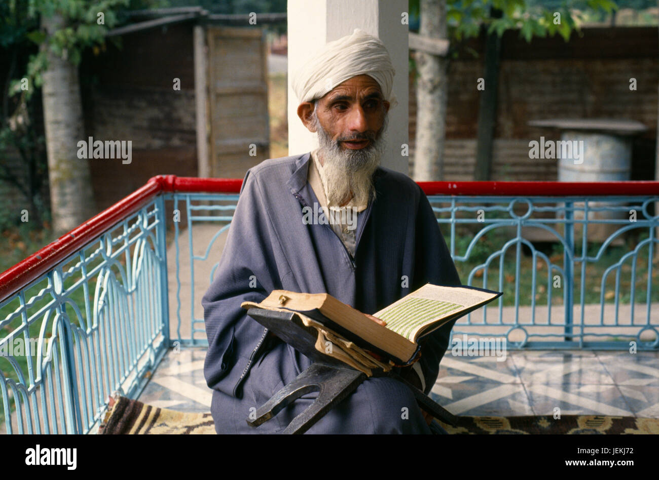 India, Kashmir, Religion, Muslim man reading from the Koran Stock Photo ...