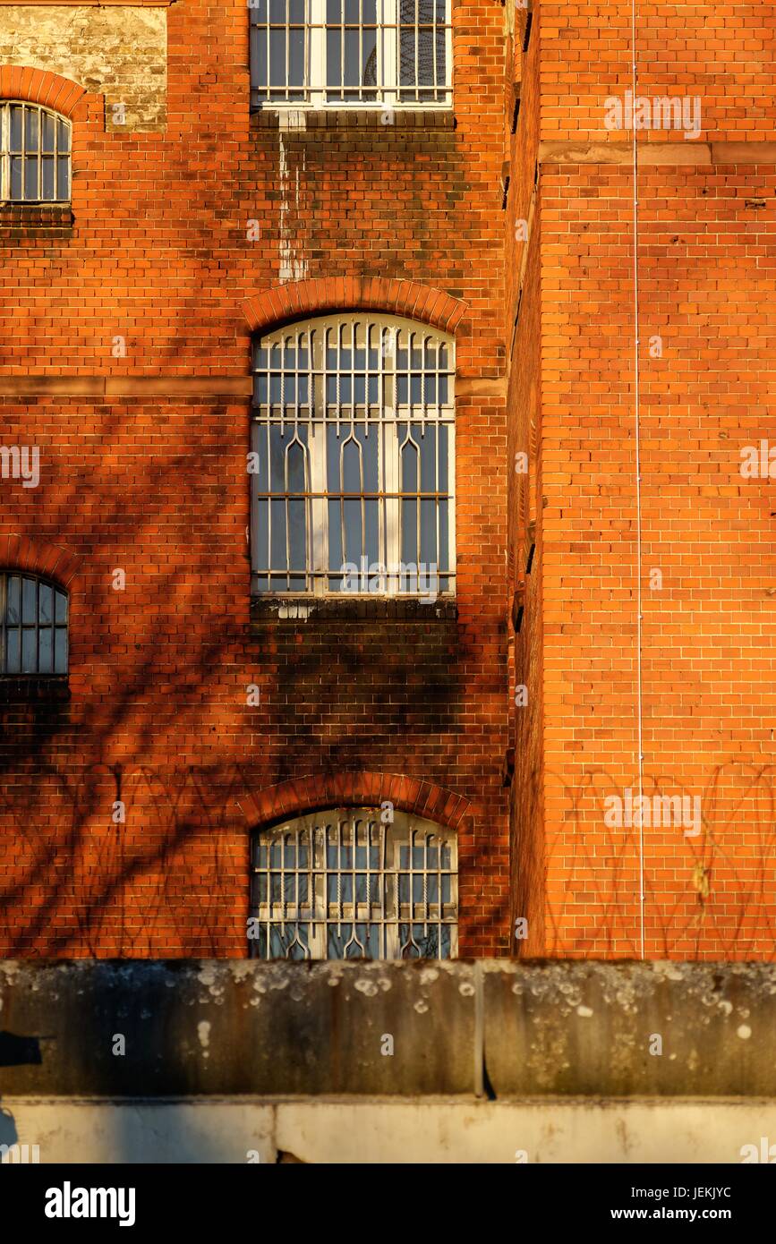 The outside view of an old and abandoned jail in Berlin during sunset ...