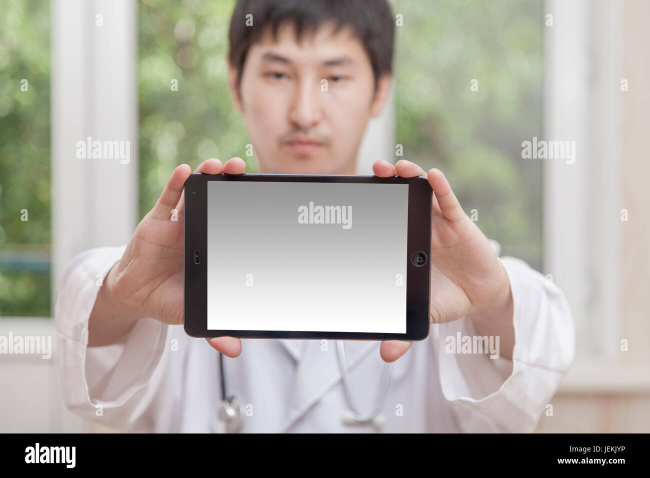The doctor holds in hand before himself a tablet Stock Photo - Alamy