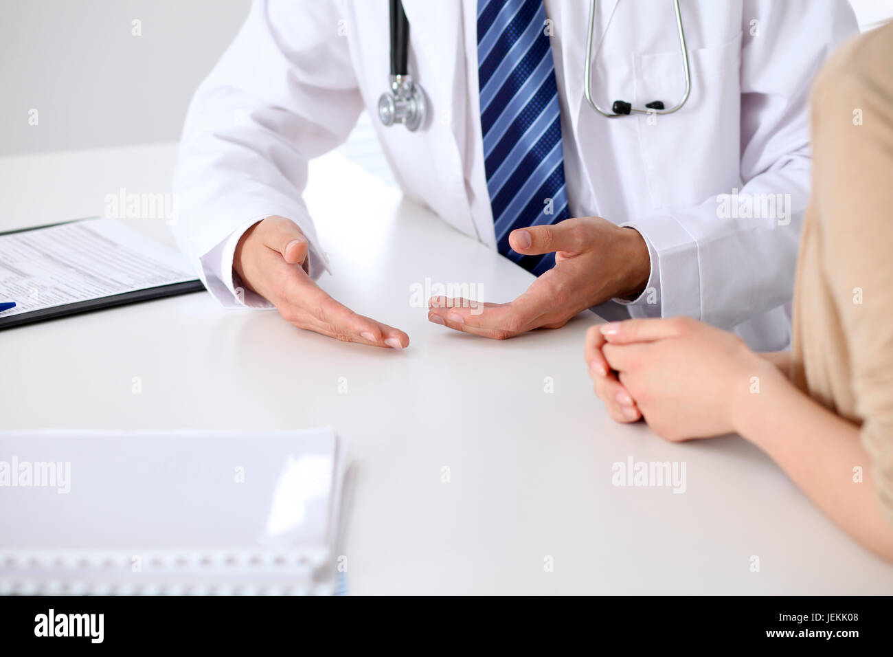 Hand of doctor reassuring her female patient. Medical ethics and trust ...