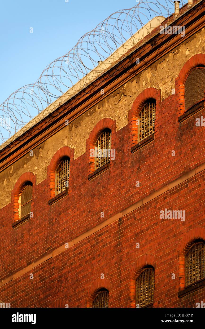 The outside view of an old and abandoned jail in Berlin during sunset ...