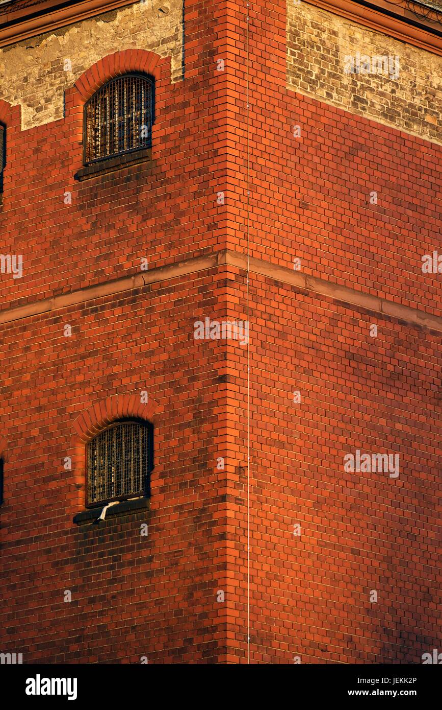 The outside view of an old and abandoned jail in Berlin during sunset ...