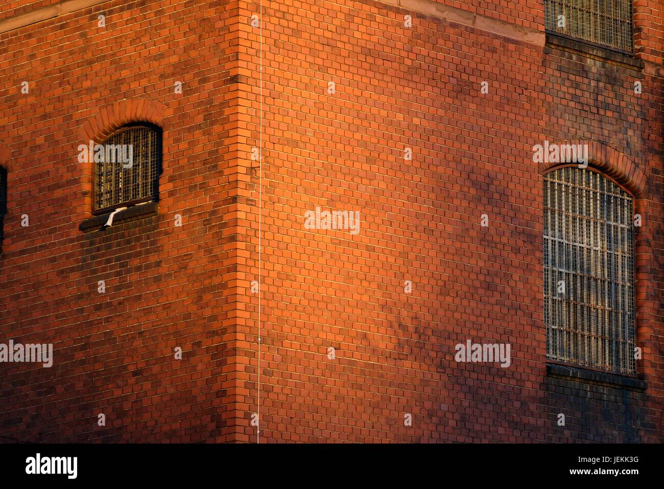 The outside view of an old and abandoned jail in Berlin during sunset ...
