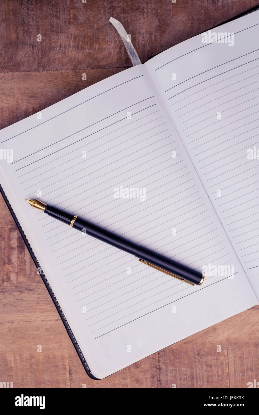 High angle view of pen on open book Stock Photo - Alamy
