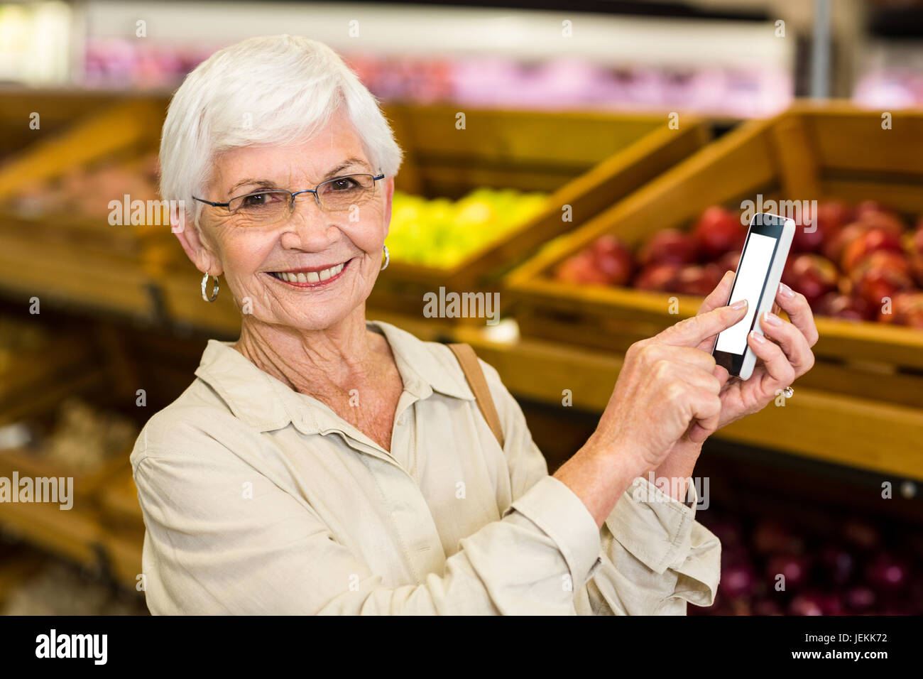 Old woman using her smartphone Stock Photo - Alamy