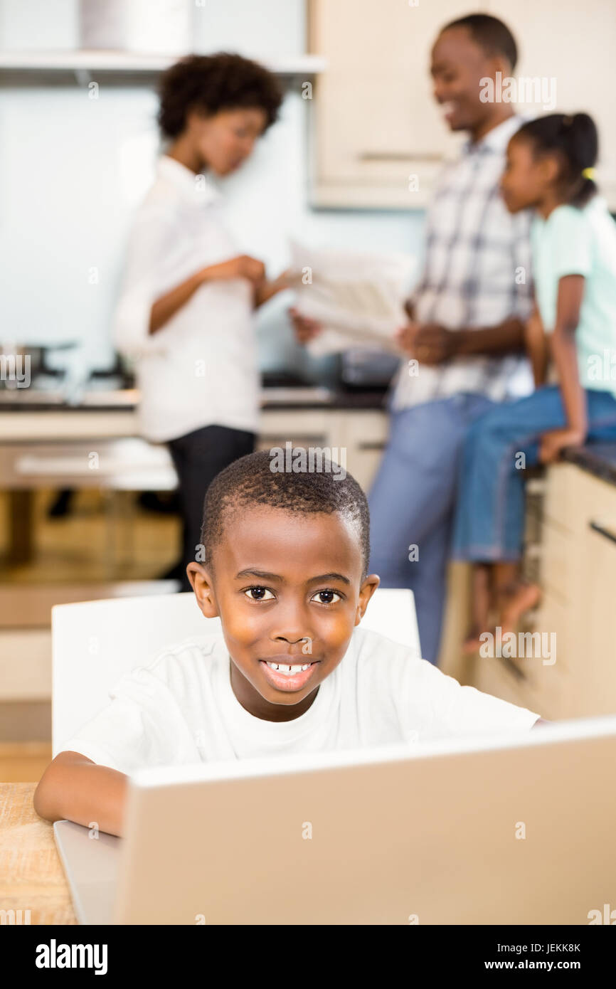 Son using laptop in the kitchen Stock Photo - Alamy